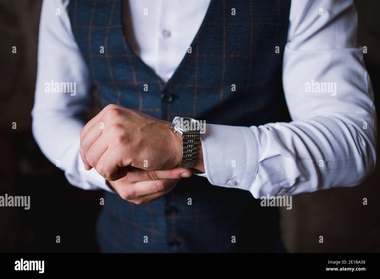 Man puts a watch hi-res stock photography and images - Alamy