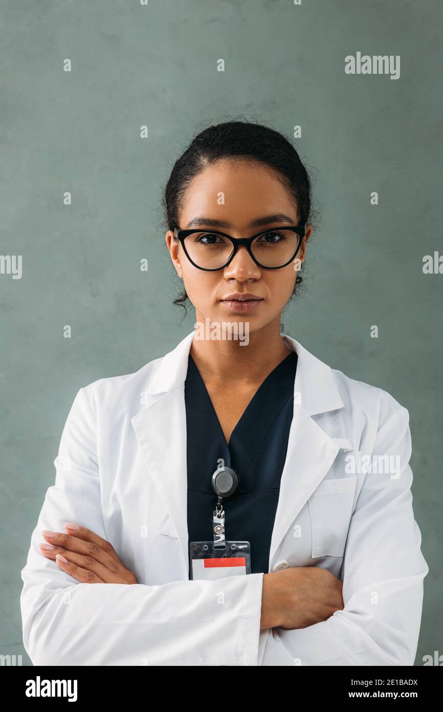 Portrait of a serious medical worker standing with crossed arms and looking at camera Stock ...