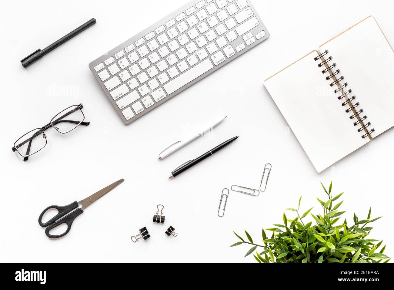Flat lay office workspace with keyboard and office supplies, top view ...