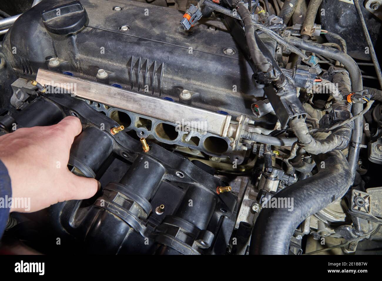 Car engine repair, intake manifold, connection of LPG injectors Stock ...