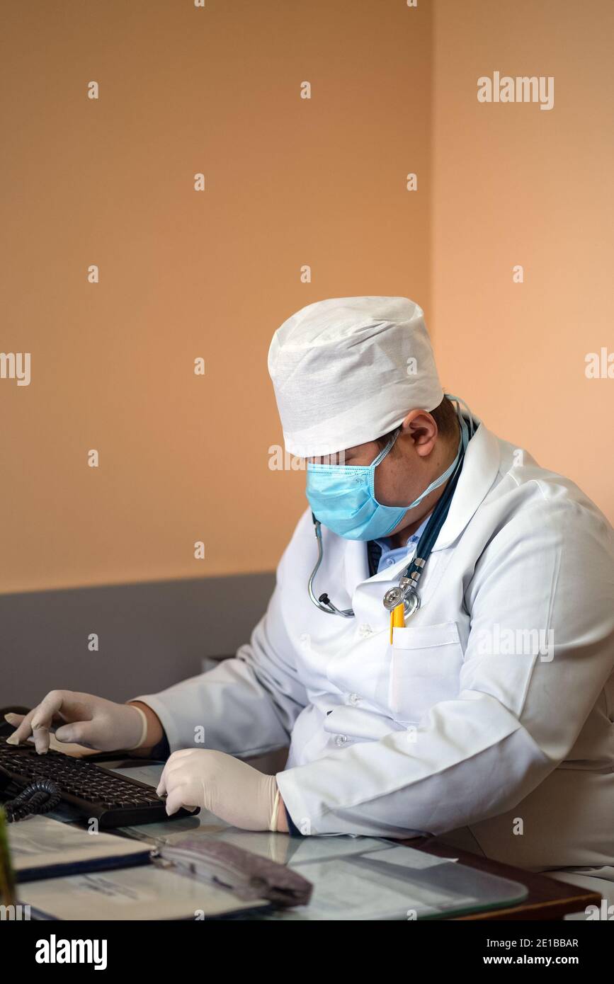 Male doctor thinking while typing hi-res stock photography and images ...