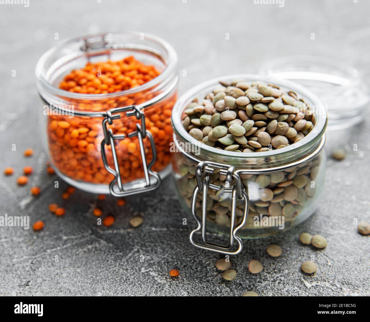 Different raw lentils on a grey concrete background Stock Photo - Alamy