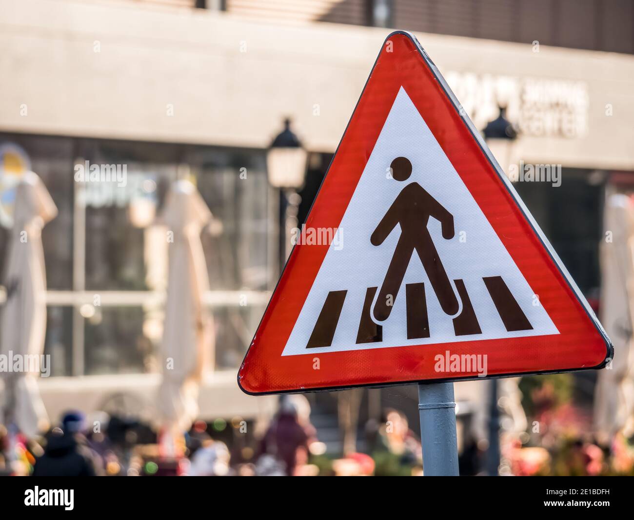 Pedestrian crossing traffic sign. Red triangle and a man crossing the ...