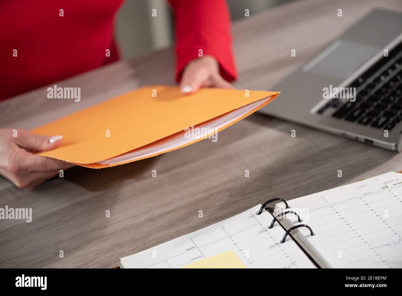 Businesswoman holding folder with paper documents Stock Photo - Alamy