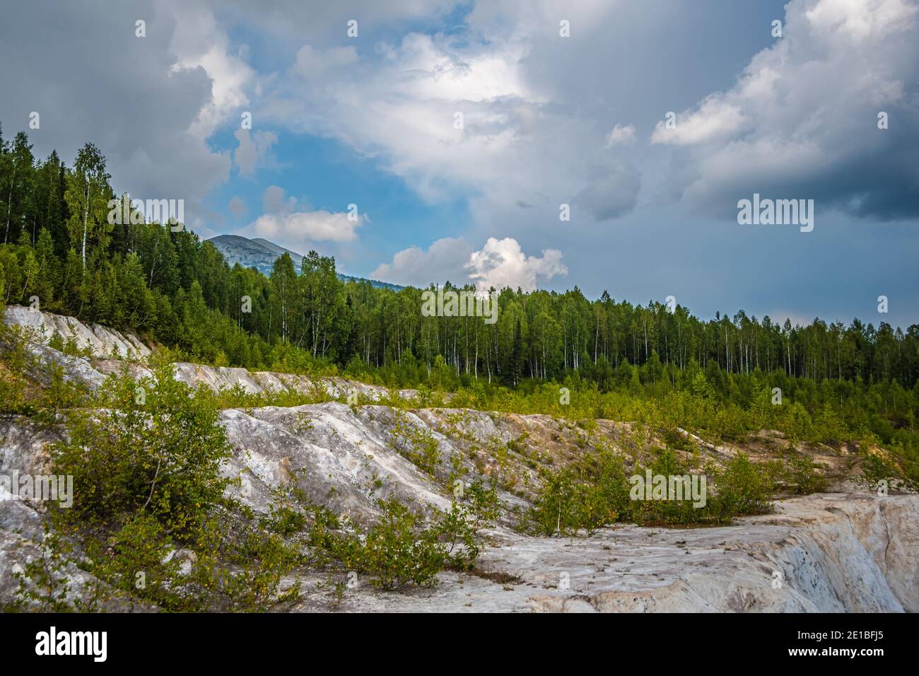 Abandoned talc quarry overgrown with trees and grass Stock Photo - Alamy