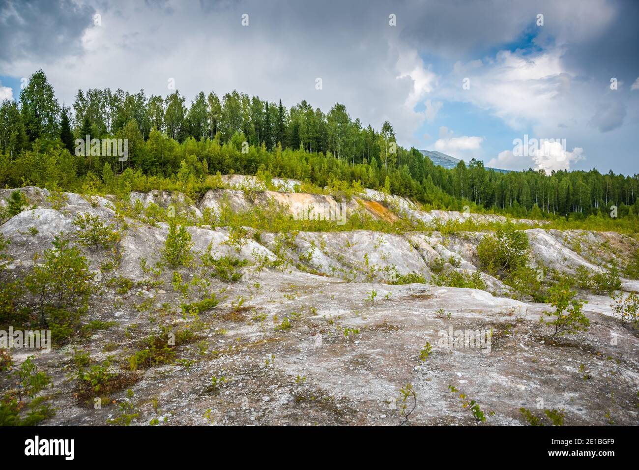 Abandoned talc quarry overgrown with trees and grass Stock Photo - Alamy