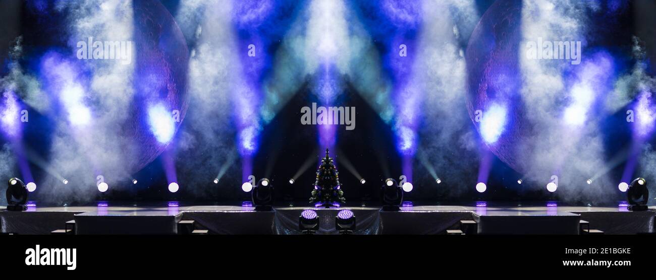 An empty stage of the theater, lit by spotlights and smoke before the ...