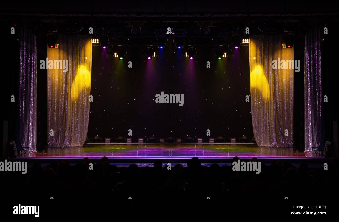 An empty stage of the scene concert hall, lit by spotlights and smoke ...