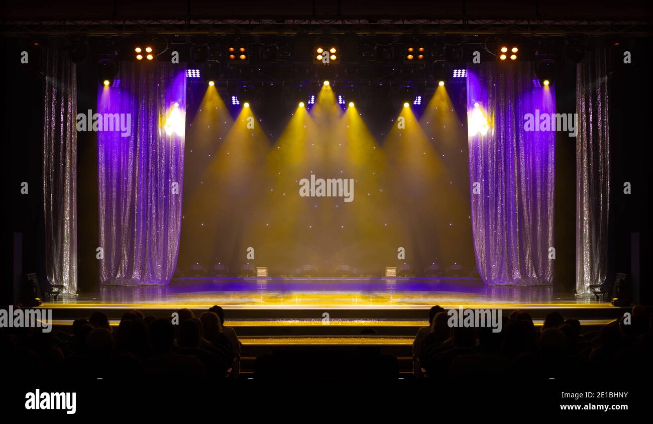 An empty stage of the scene concert hall, lit by spotlights and smoke ...