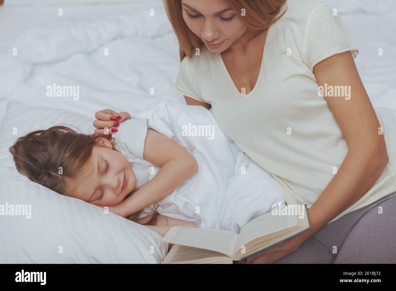 Cropped shot of a beautiful woman enjoying reading fairytale book to ...