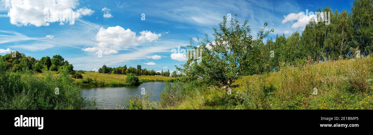 Bright summer panoramic landscape with beautiful lake and green hills ...