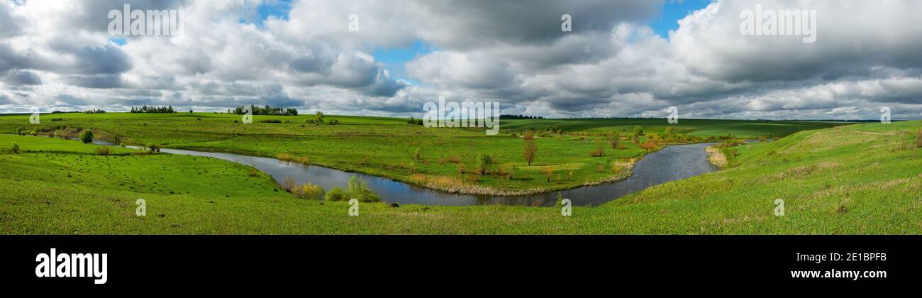 Spring panoramic rural landscape with river and green fields Stock ...