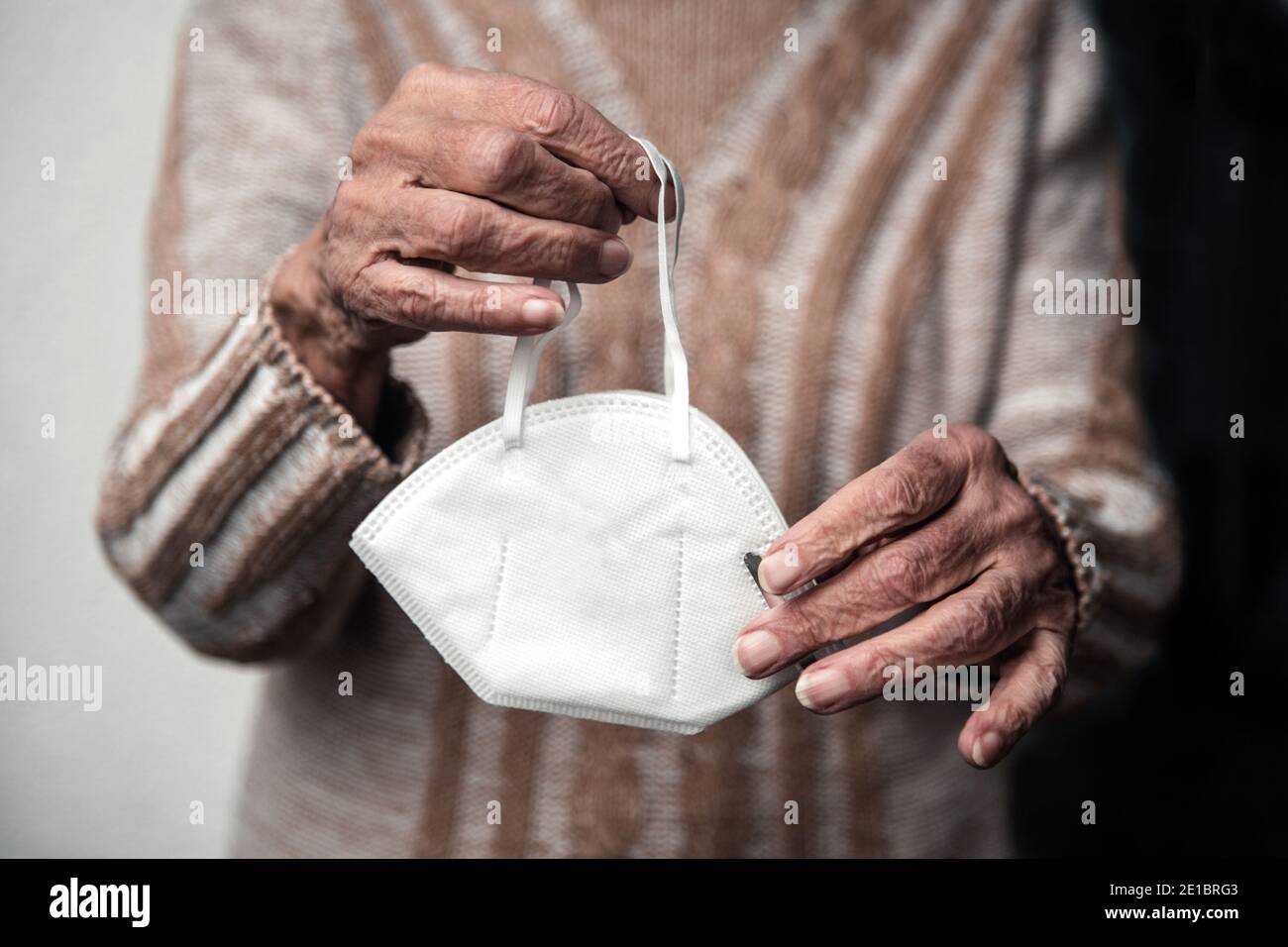Hands holding face mask hi-res stock photography and images - Alamy