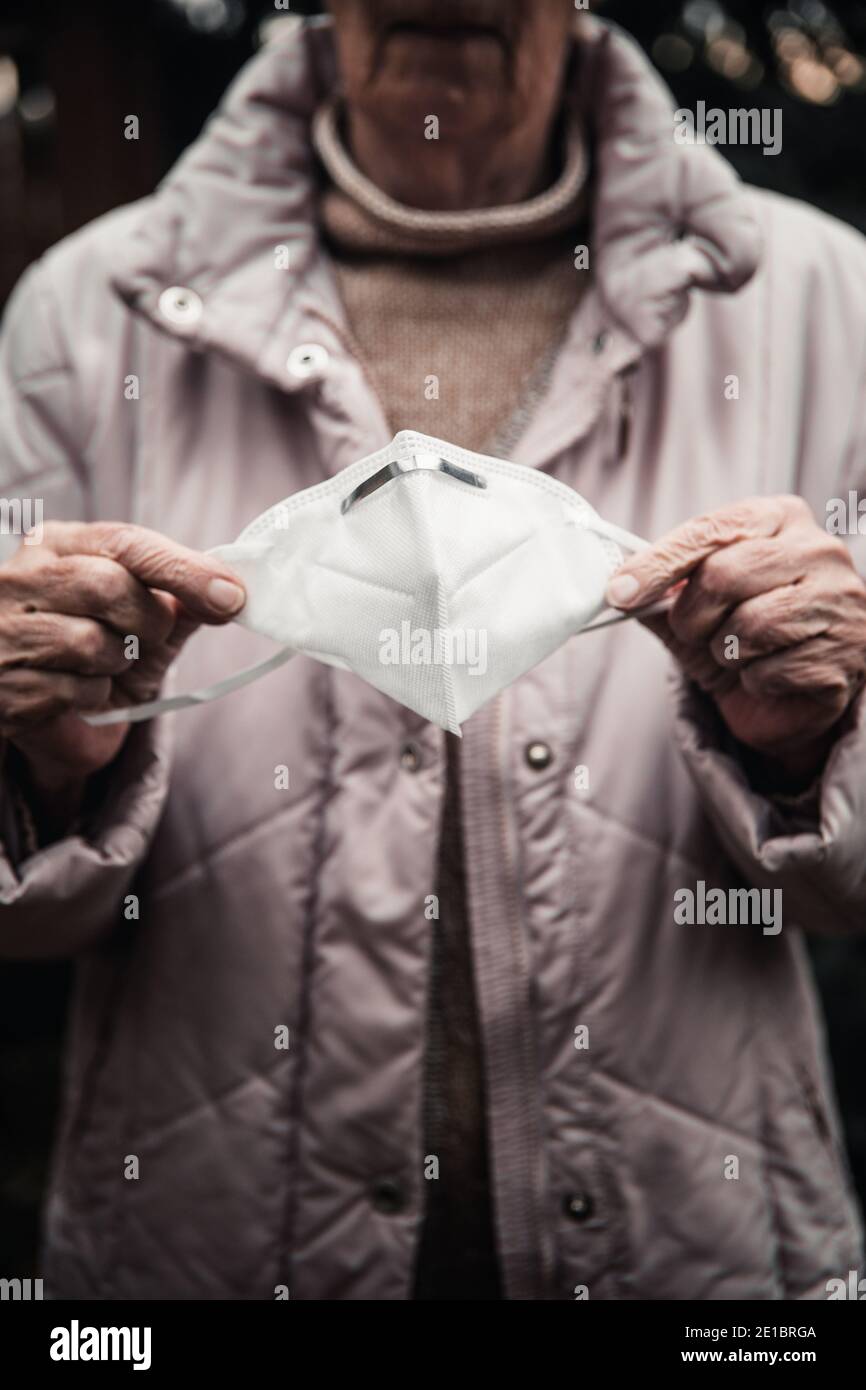 Hands holding face mask hi-res stock photography and images - Alamy