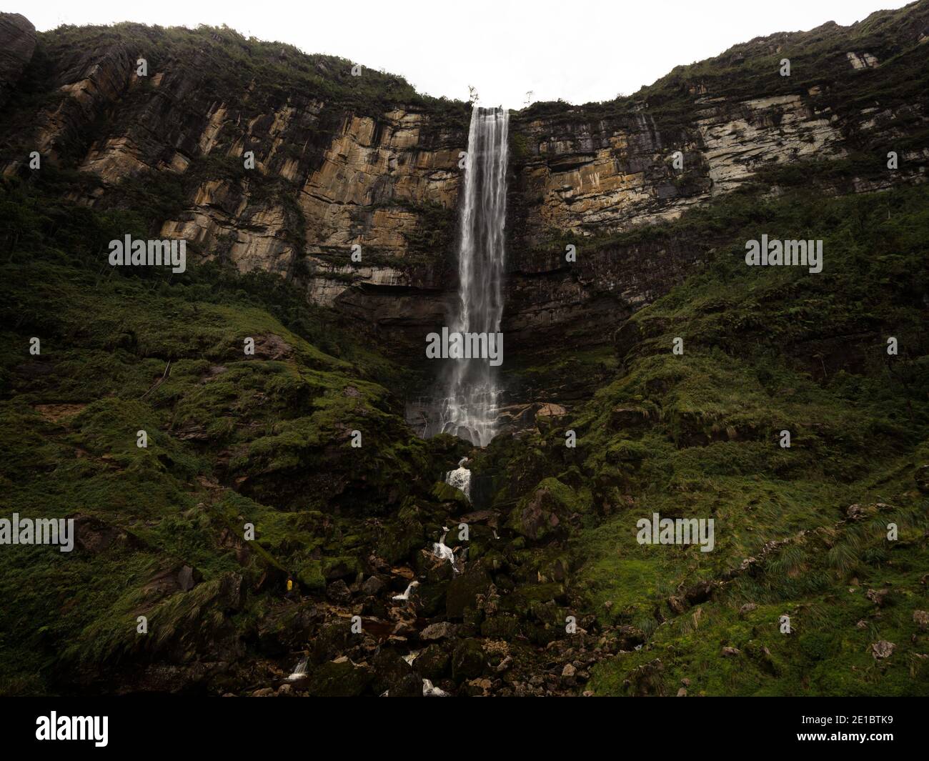 Tiny hiker in yellow jacket at Catarata del Gocta waterfall cataract ...
