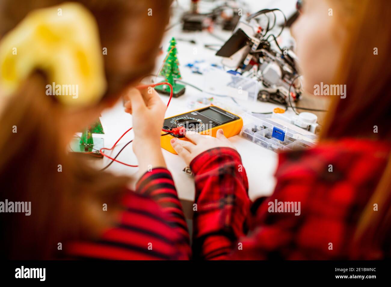 Group of happy kids programming electric toys and robots at robotics ...
