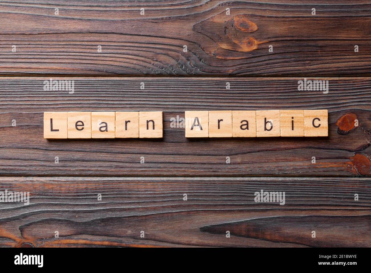 learn arabic word written on wood block. learn arabic text on table ...