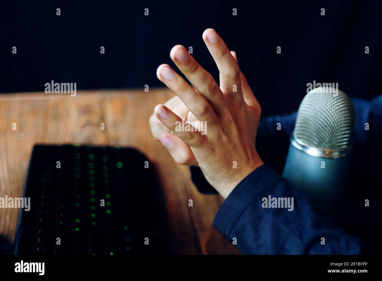 Gamer shows sings of victory. Crazy gamer Streamer show gestures. Neon ...