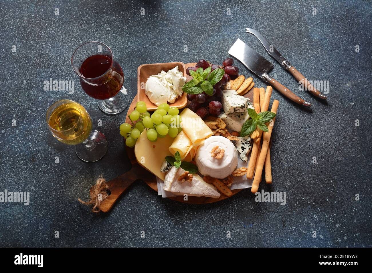 Cheese platter with assorted cheeses, grapes, nuts and snacks . Italian ...