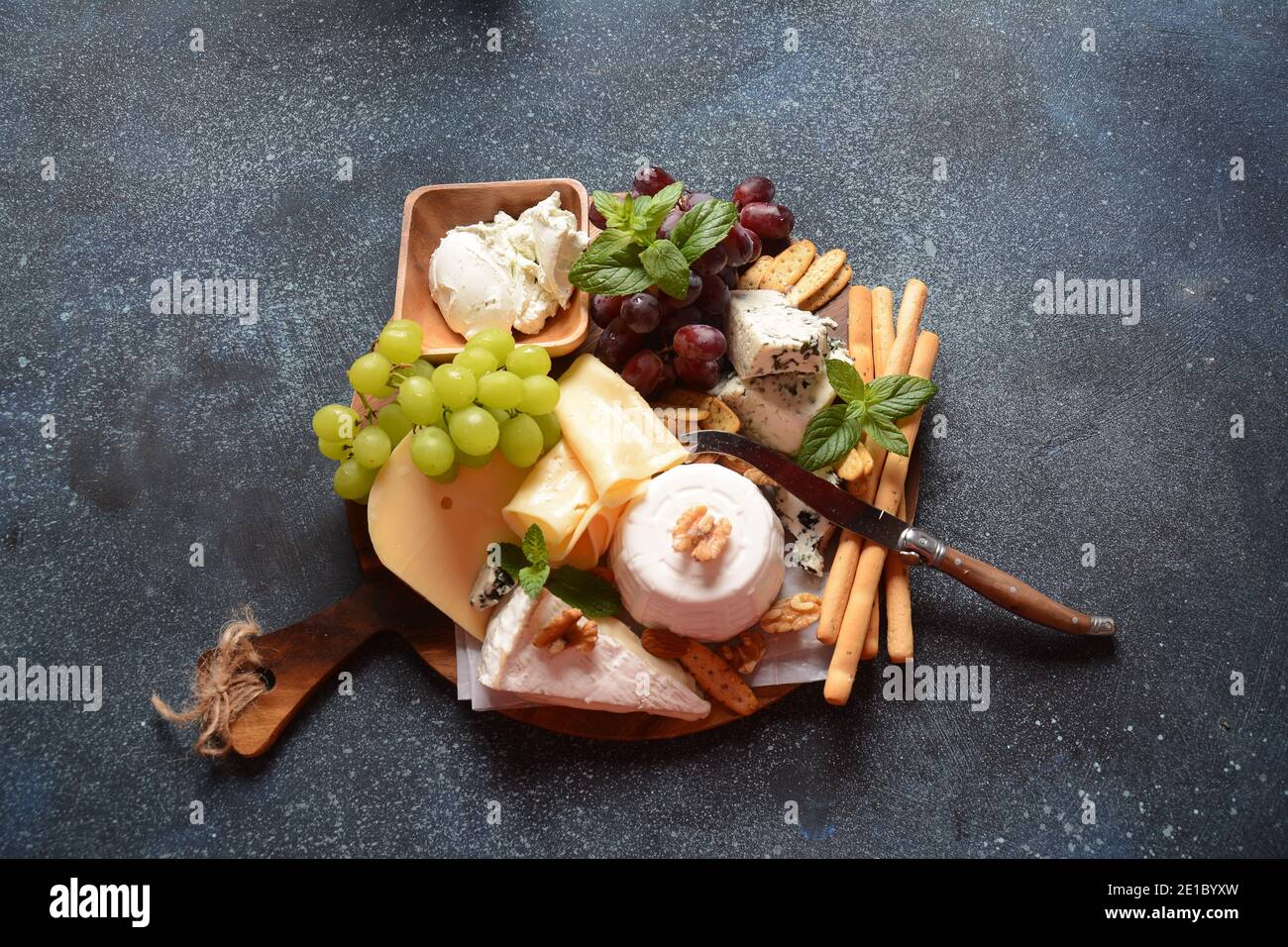 Cheese platter with assorted cheeses, grapes, nuts and snacks . Italian ...