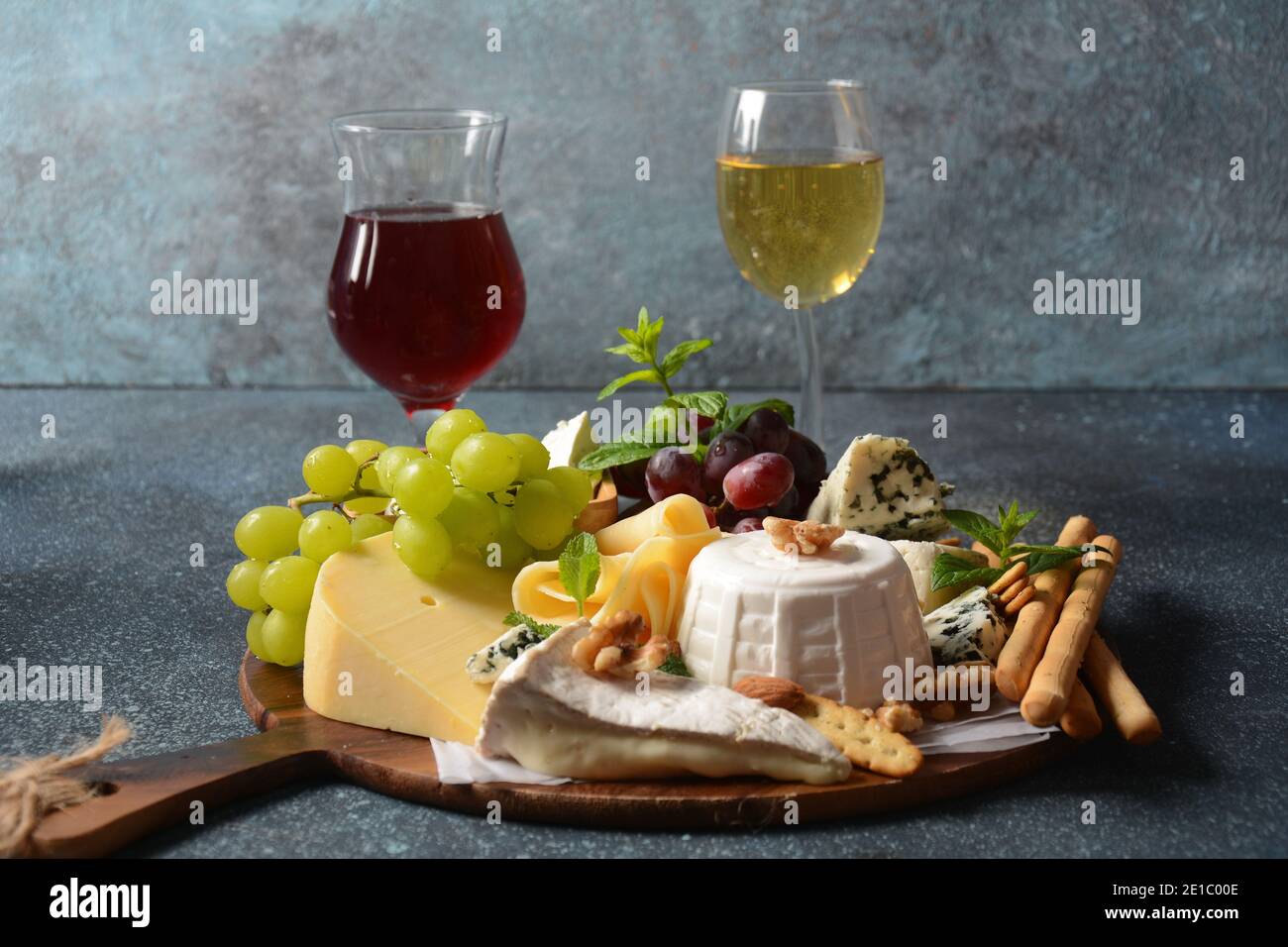 Cheese platter with assorted cheeses, grapes, nuts and snacks . Italian ...