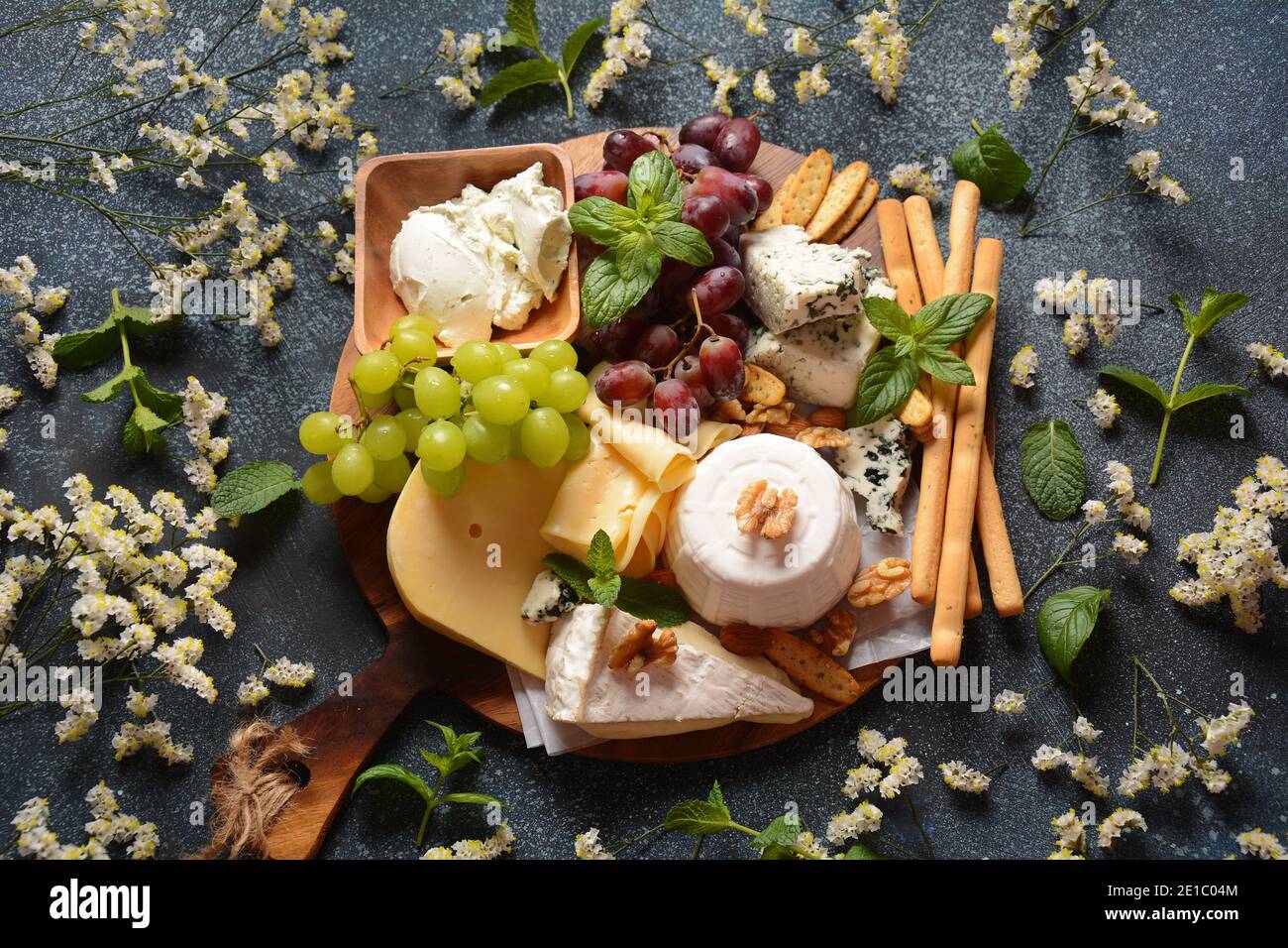 Cheese platter with assorted cheeses, grapes, nuts and snacks . Italian ...