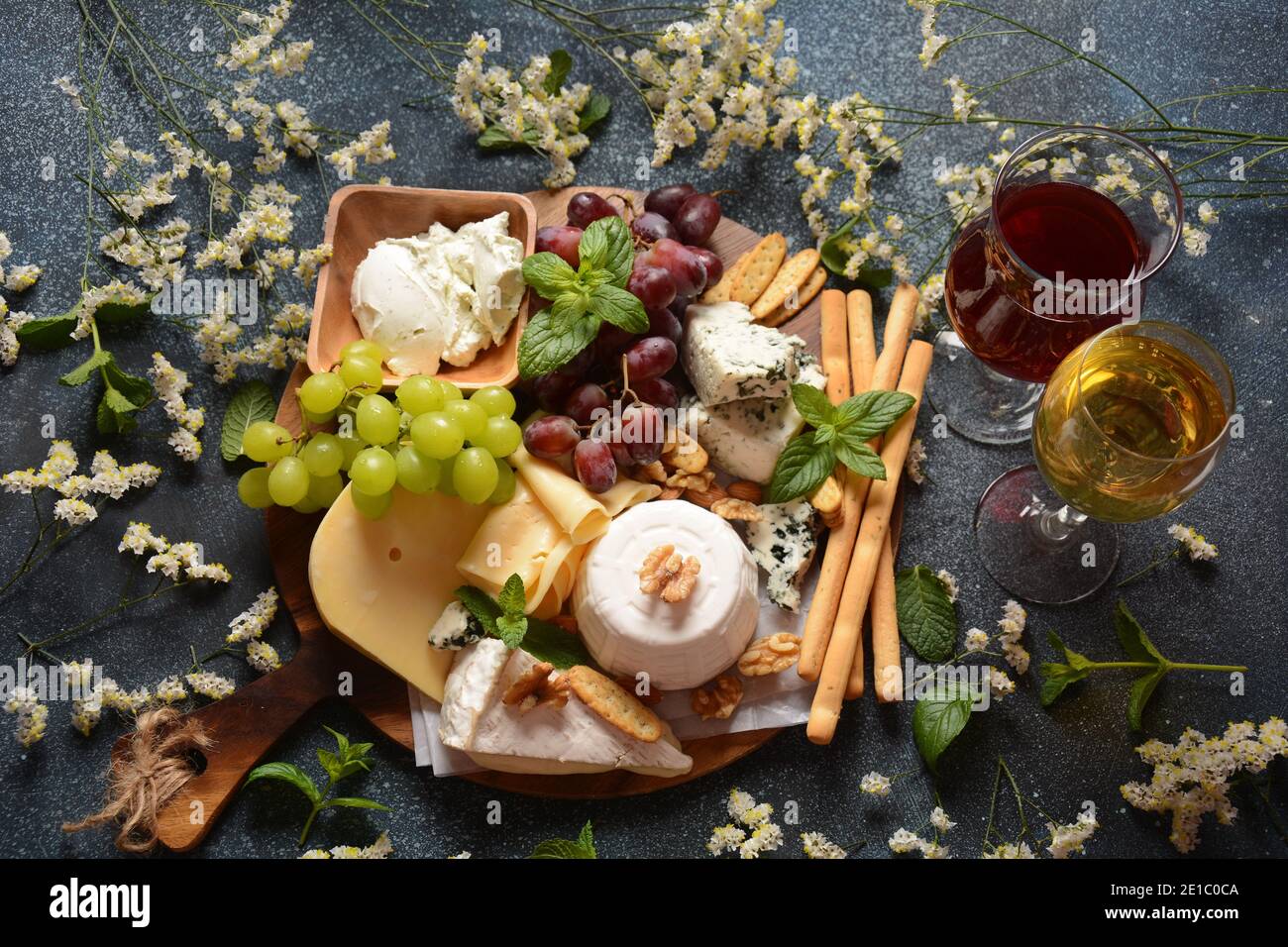 Cheese platter with assorted cheeses, grapes, nuts and snacks . Italian ...