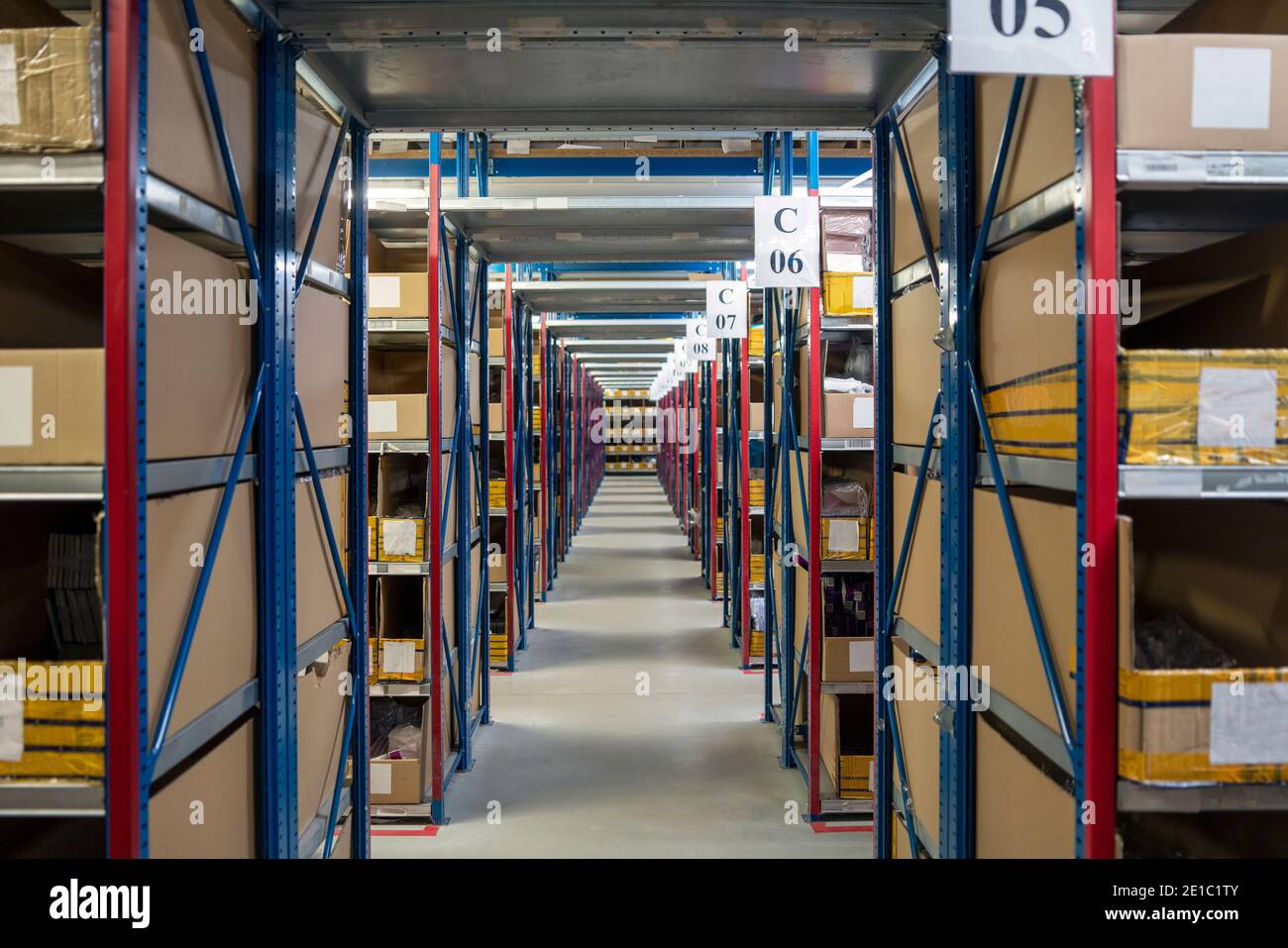 Long corridor in big, modern warehouse full of goods Stock Photo - Alamy