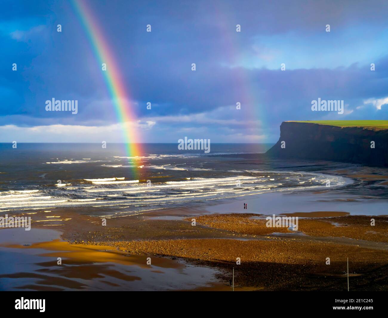 Saltburn Beach in winter sunshine blue sky with a double rainbow and a ...