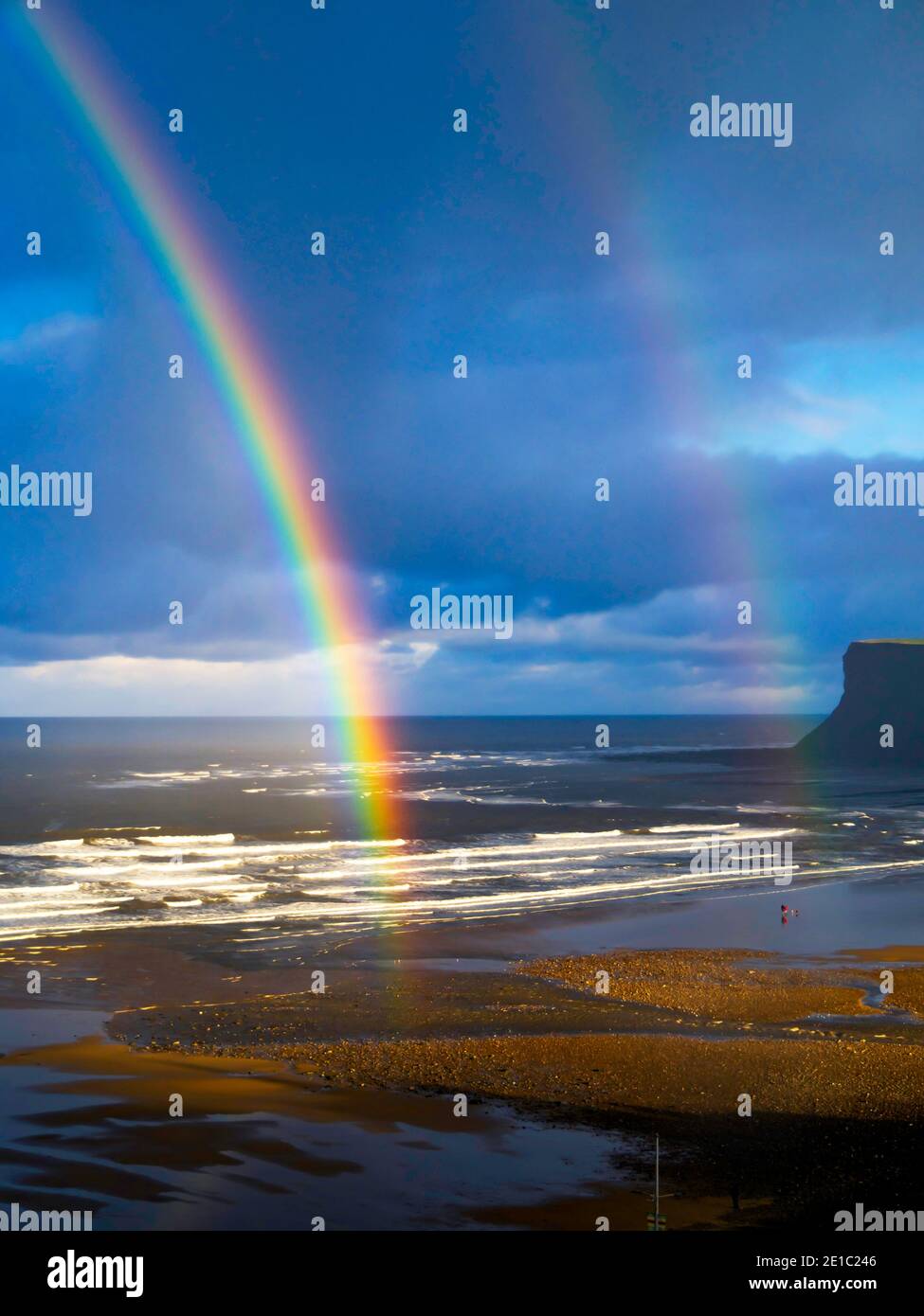 Saltburn Beach in winter sunshine blue sky with a double rainbow and a ...