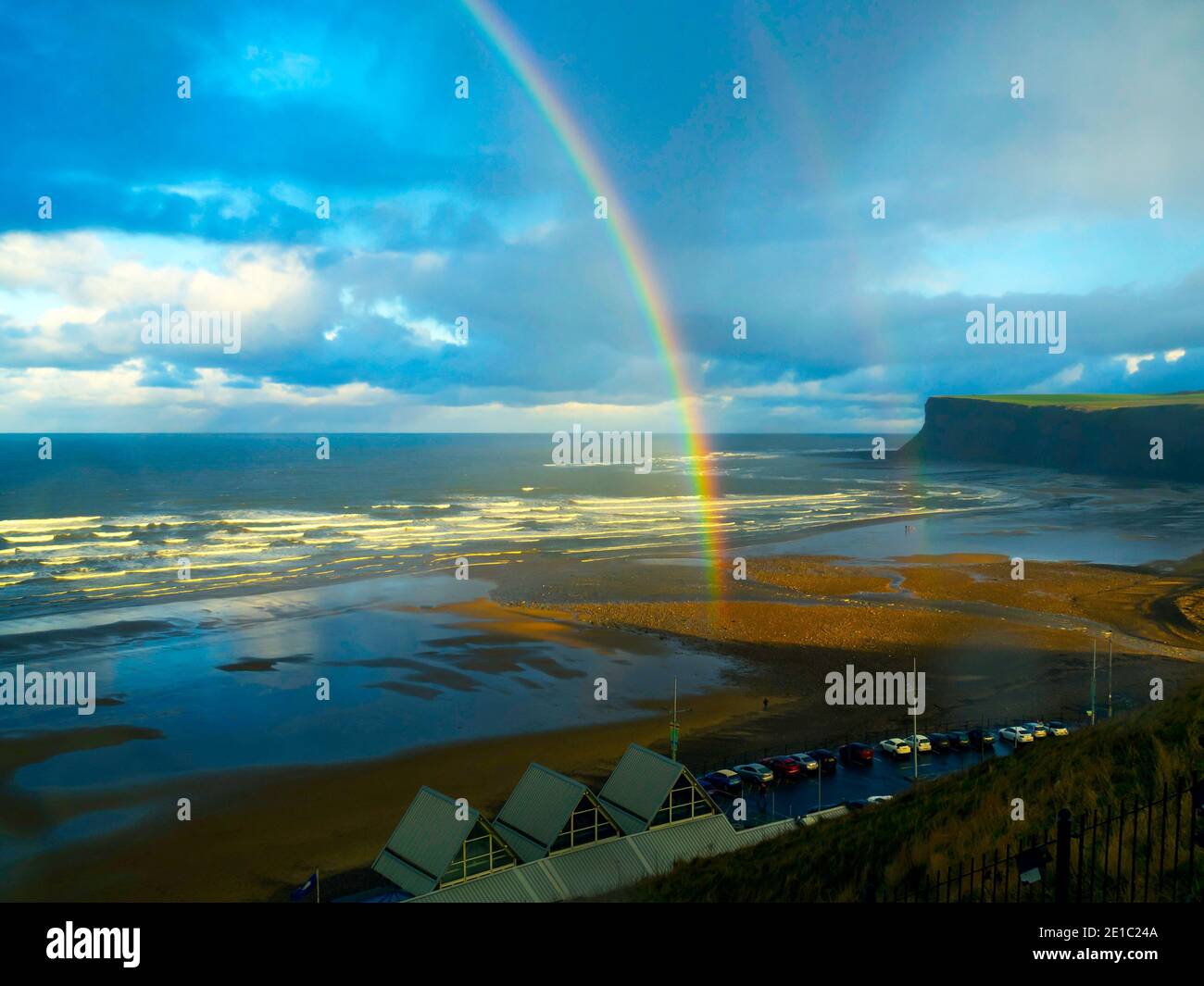 Saltburn Beach in winter sunshine blue sky with a double rainbow and a ...