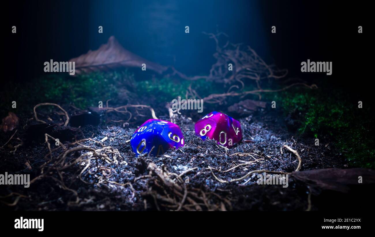 Close-up rpg scene of two 10-sided dice in a beam of light Stock Photo ...