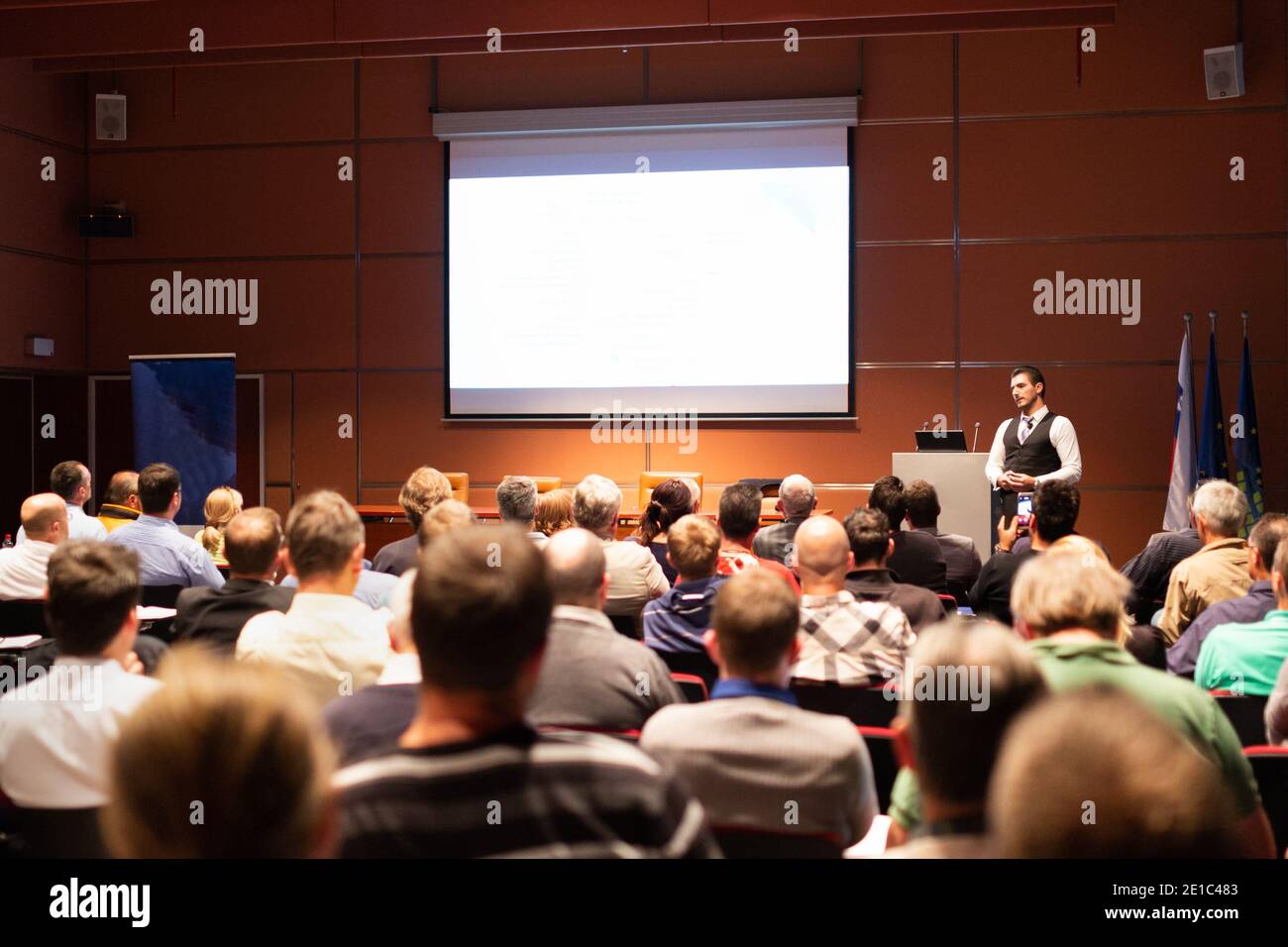 Business speaker giving a talk at business conference meeting event ...