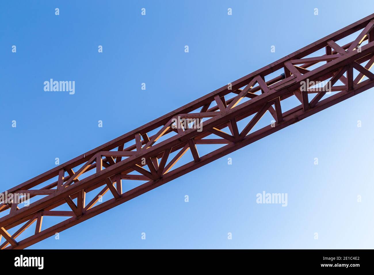 straight red steel welded truss on blue sky background Stock Photo - Alamy