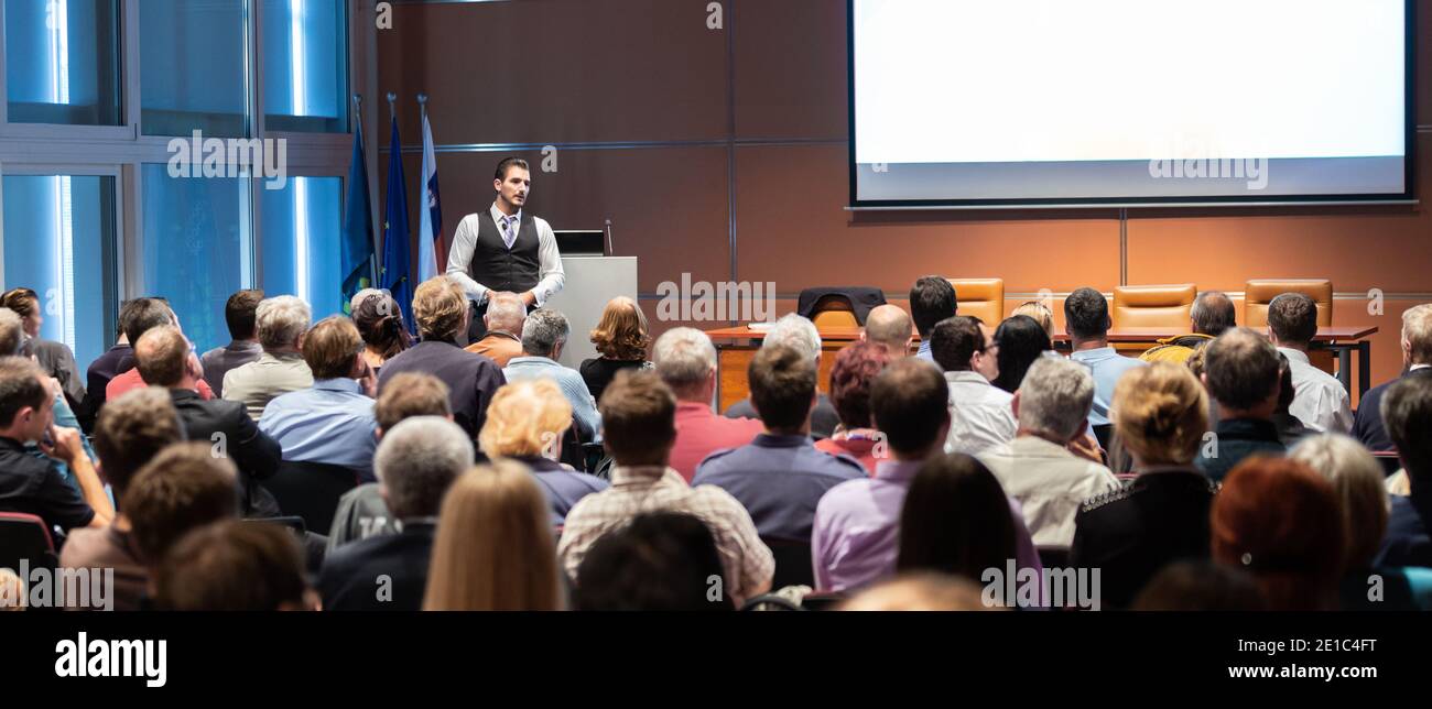 Business speaker giving a talk at business conference meeting event ...