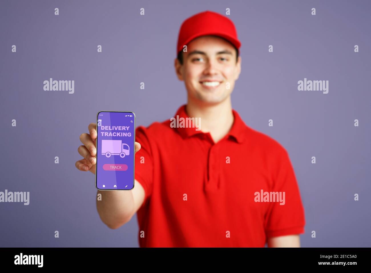 Courier man holding mobile phone with delivery tracking app Stock Photo ...