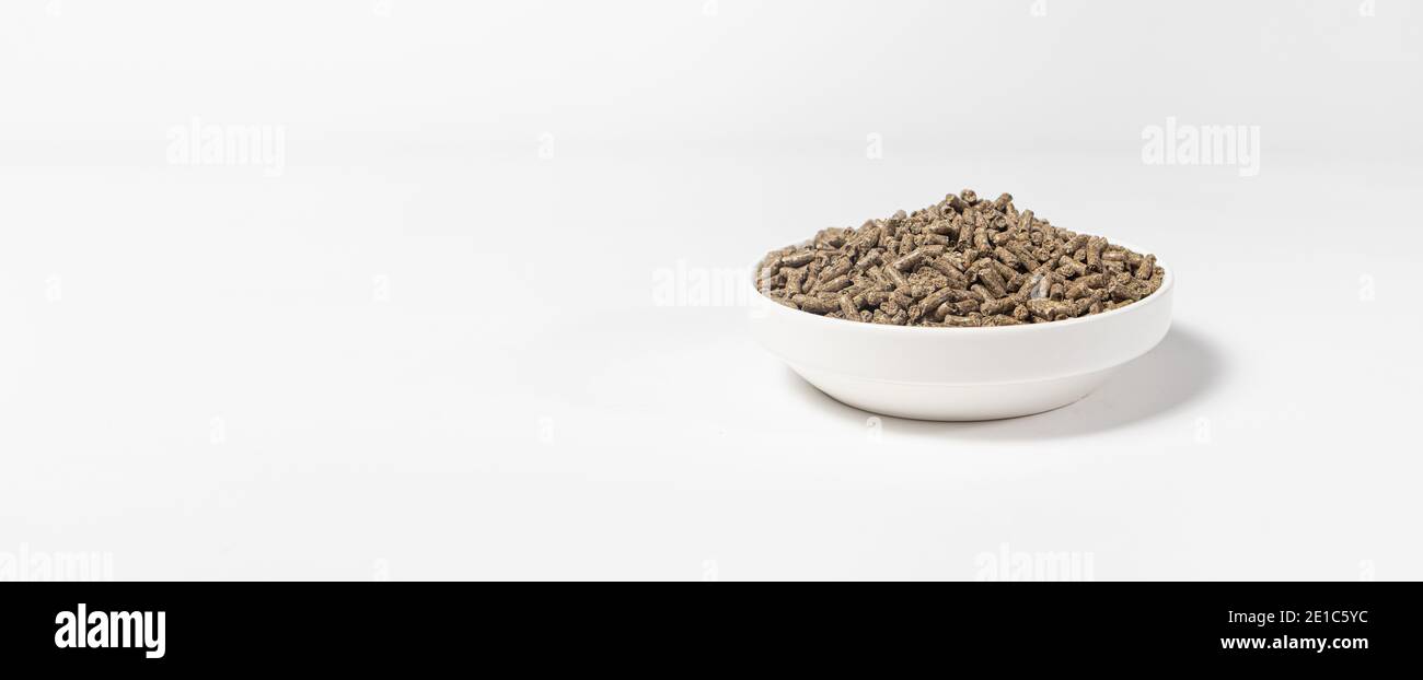 Compound feed for rabbits in a plate on a white background. Rabbit food ...