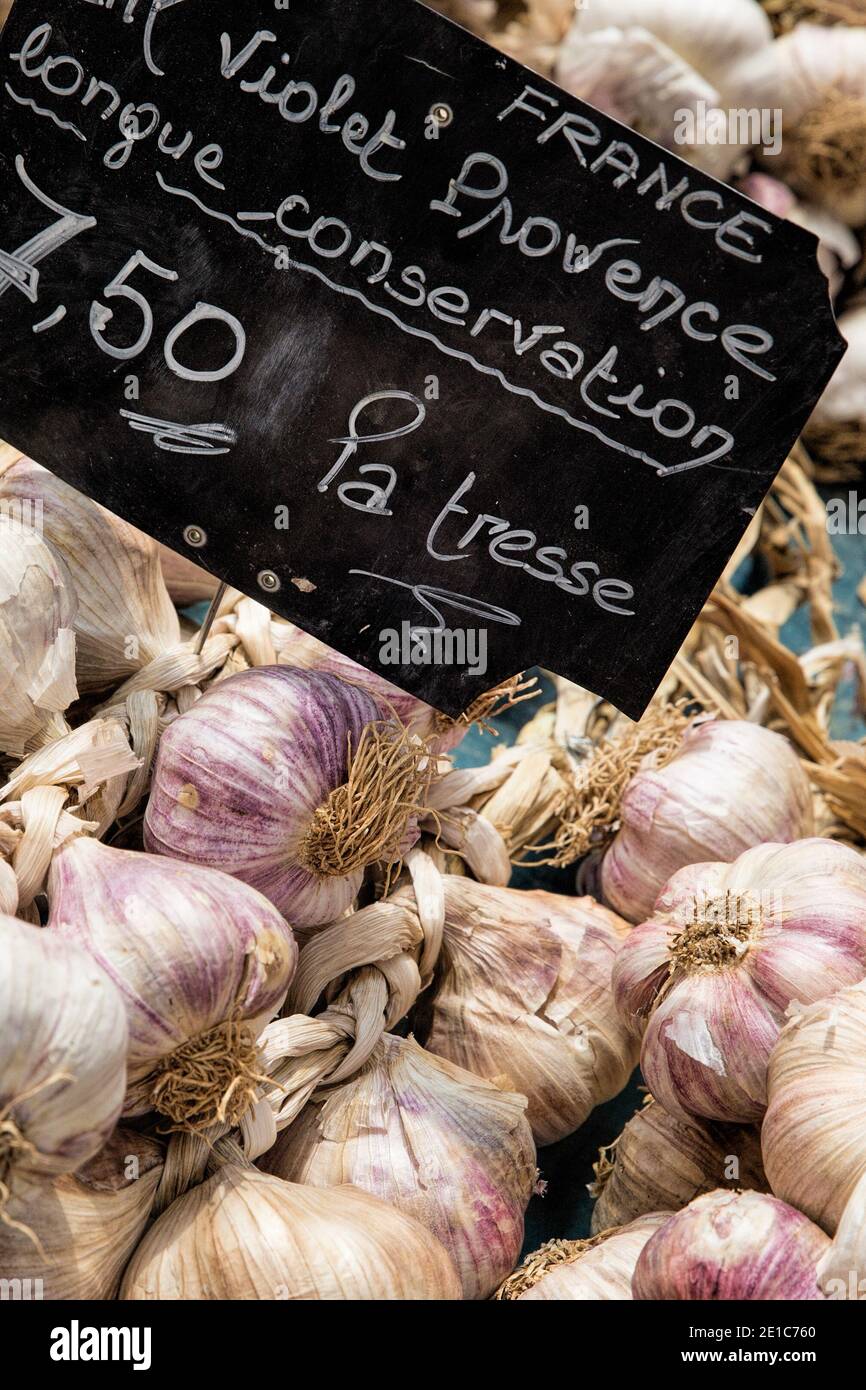 Close-up view of garlic for sale at the Nice market; the price tag is ...