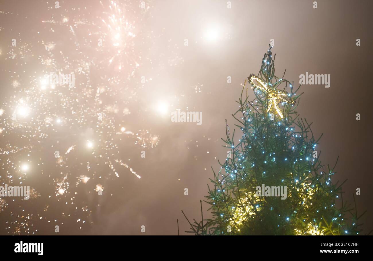 Decorated Christmas tree and fireworks in the sky Stock Photo - Alamy