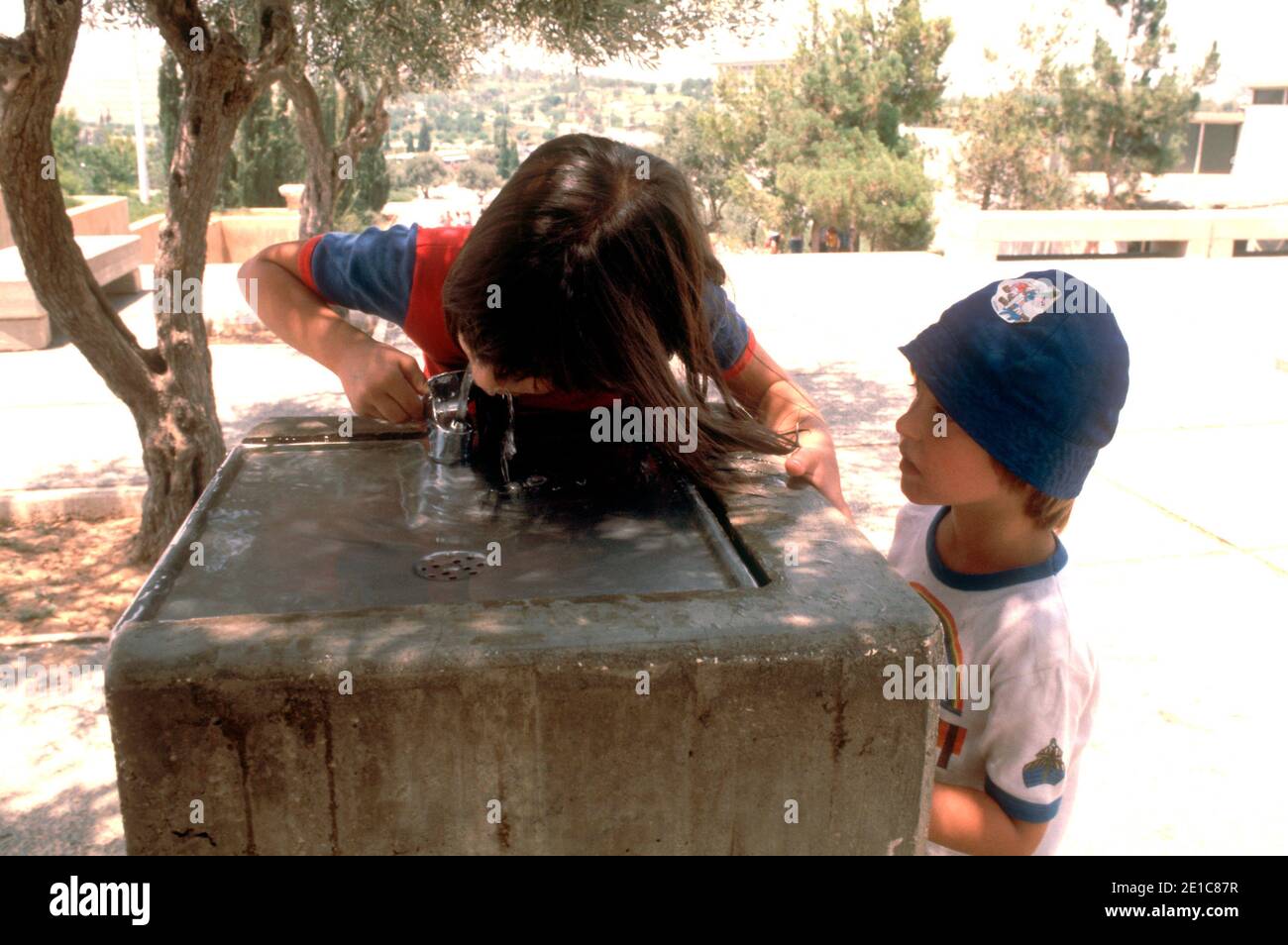 Two children at a water fountain in the Rose Memorial Garden, Jerusalem ...