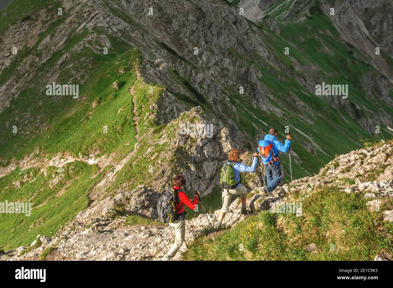 Hikers on the way in the early morning sun Stock Photo - Alamy