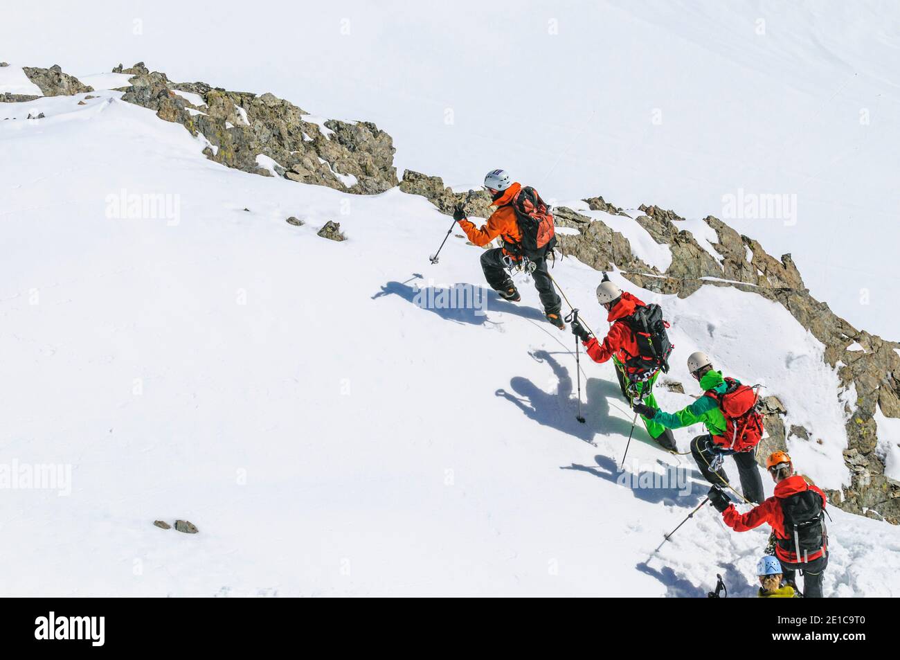 Mountain guide leading a group of alpinists up to Monte Rosa Glaciers ...