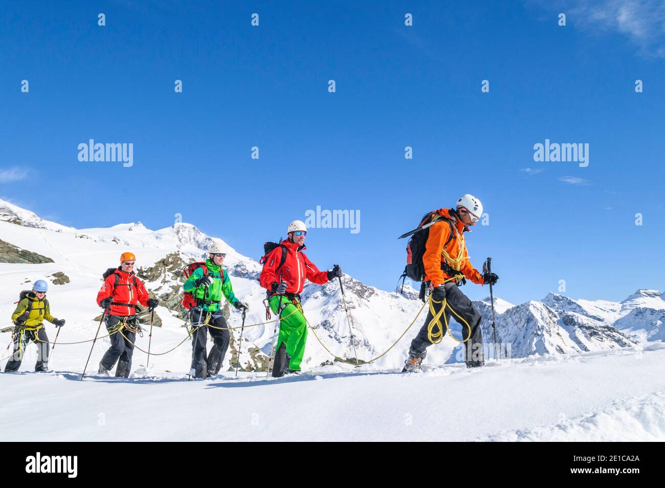 Mountain guide leading a group of alpinists up to Monte Rosa Glaciers ...