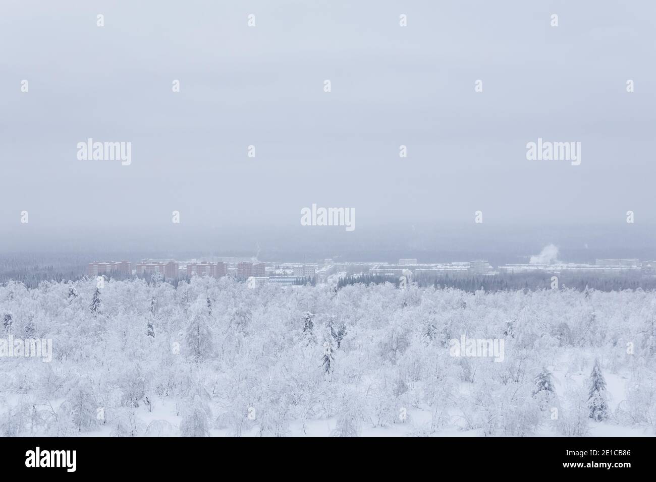winter landscape - a distant town in a valley in the middle of snow ...