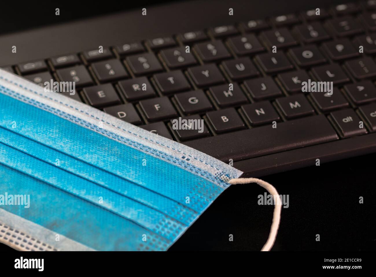 Selective focus on surgical mask isolated on laptop keyboard Stock ...