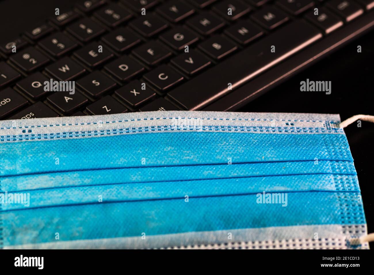 Selective focus on surgical mask isolated on laptop keyboard Stock ...