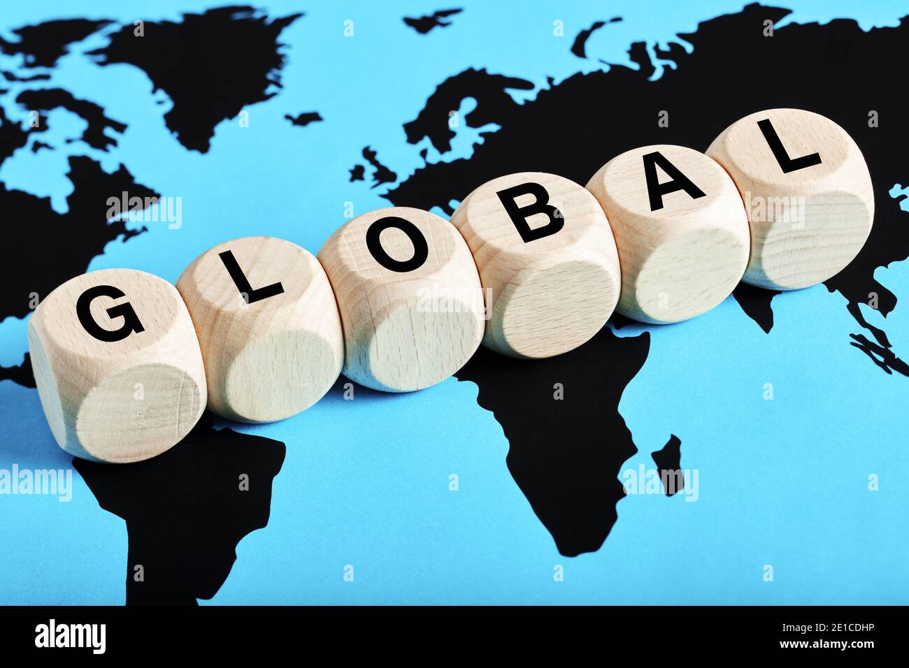 The word global written on wooden cubes on world map background ...