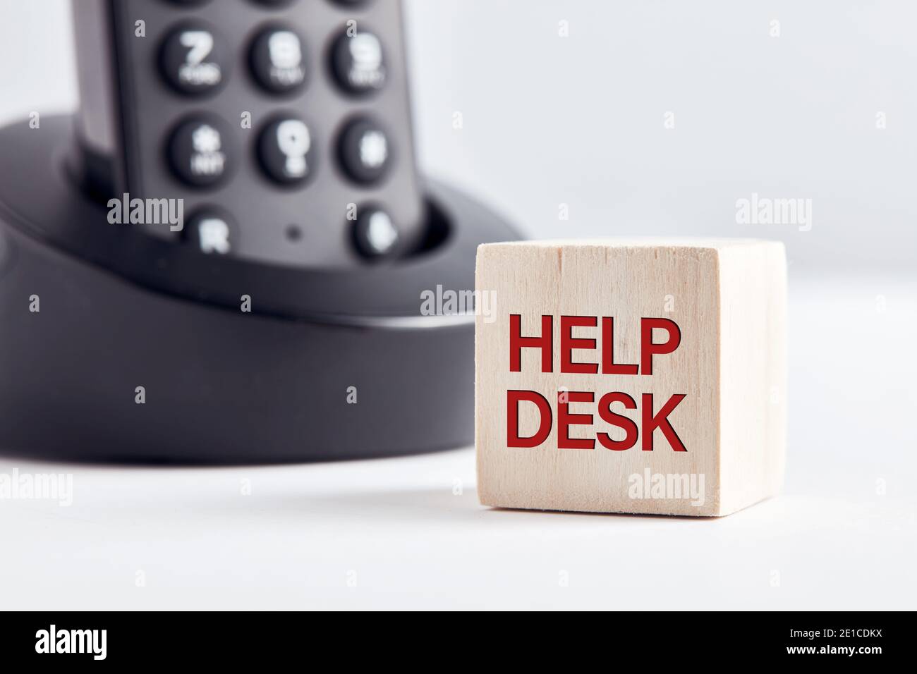 The word help desk on wooden block with telephone background. Business ...