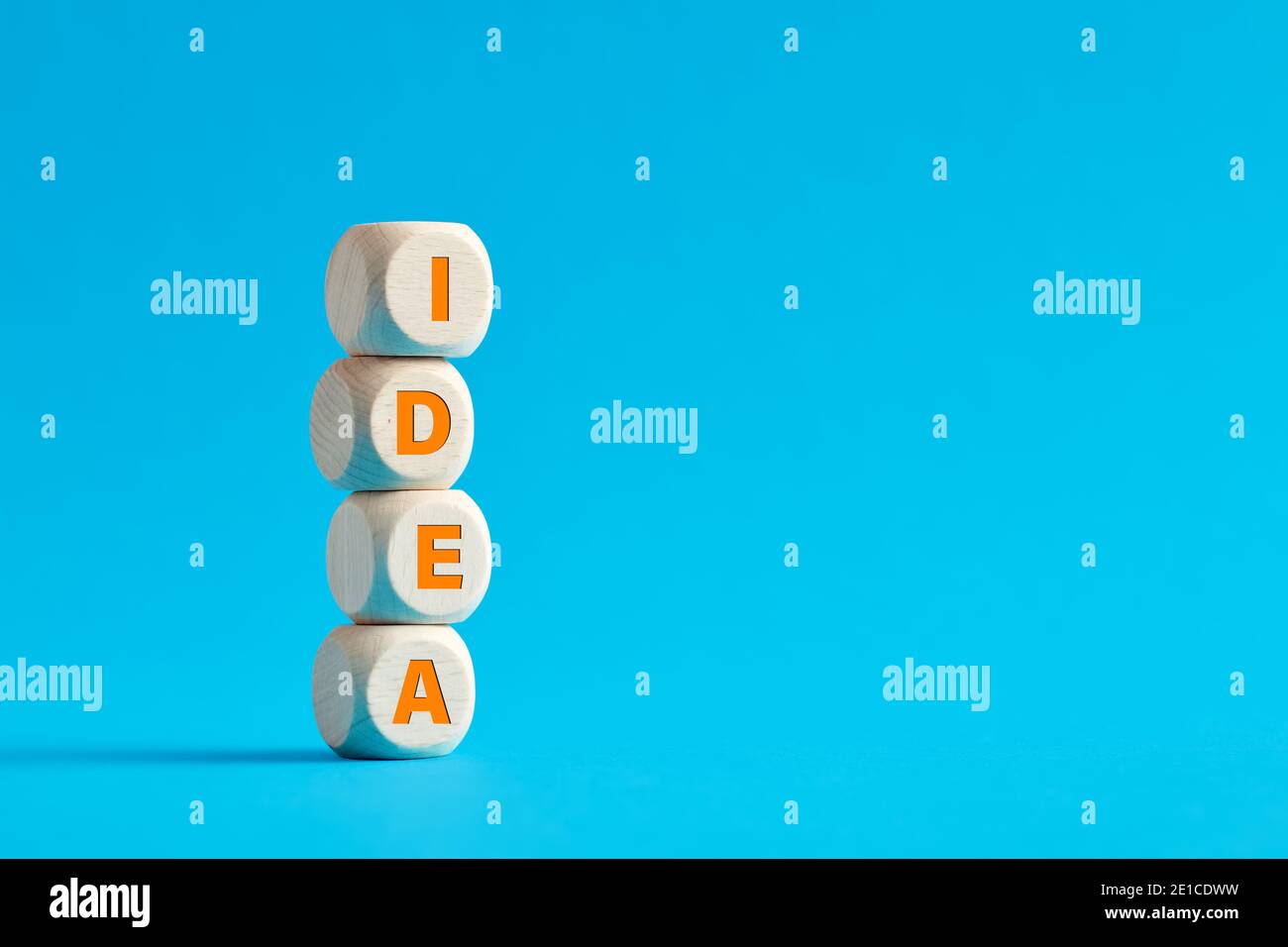 The word idea on tiered wooden cubes on blue background. Idea ...