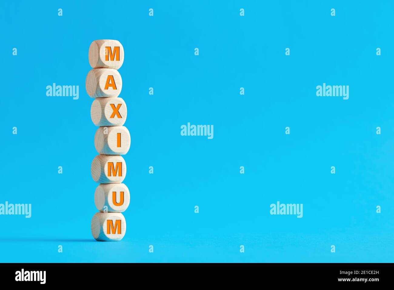 The Word Maximum On Tiered Wooden Cubes On Blue Background Stock Photo the-word-maximum-on-tiered-wooden-cubes-on-blue-background-stock-photo